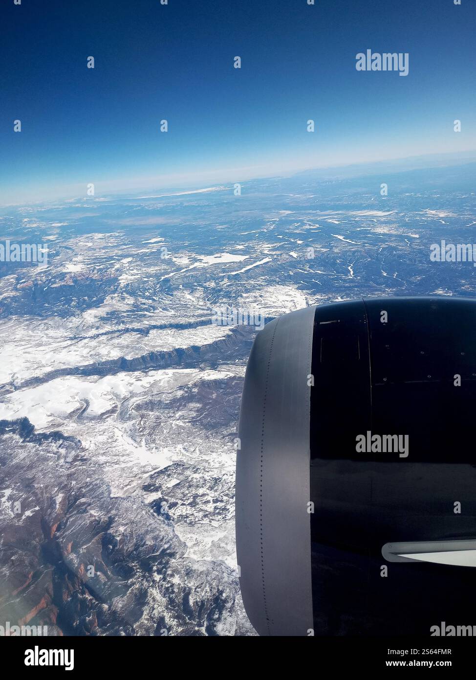 Window view of airplane flying over snowy mountains of Vancouver Canada ...