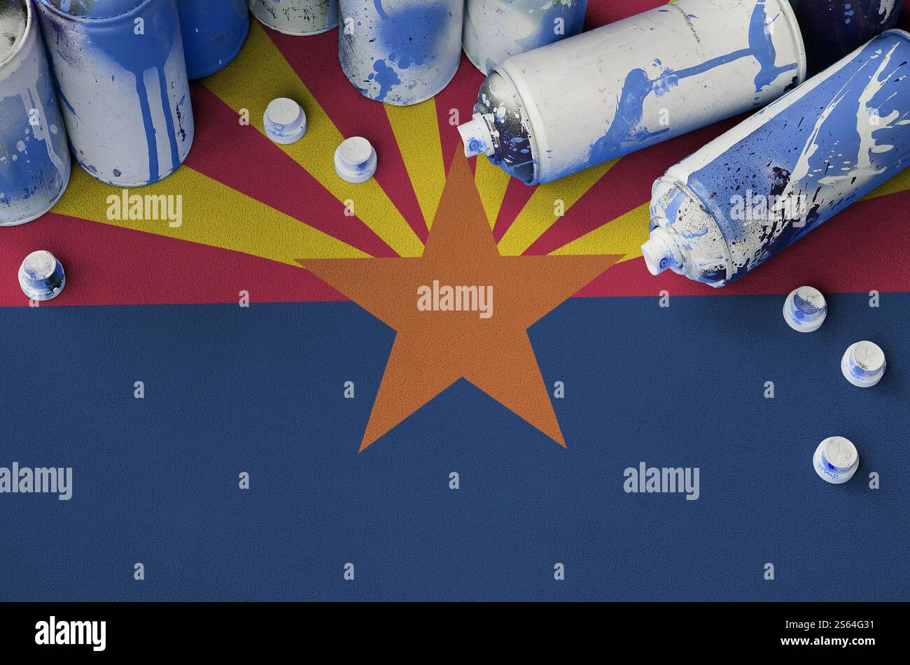 Arizaona US state flag and few used aerosol spray cans for graffiti ...