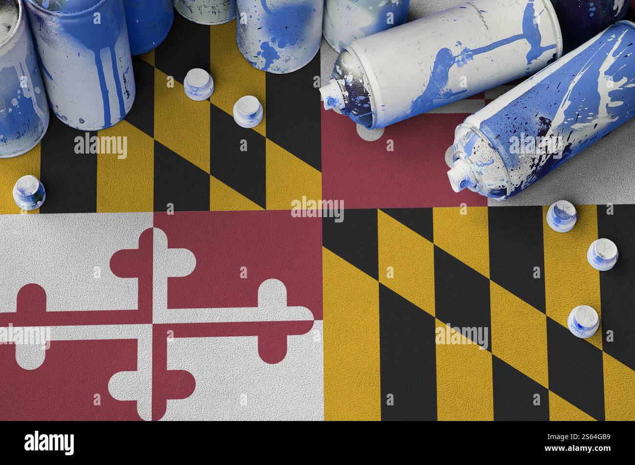 Maryland US state flag and few used aerosol spray cans for graffiti ...