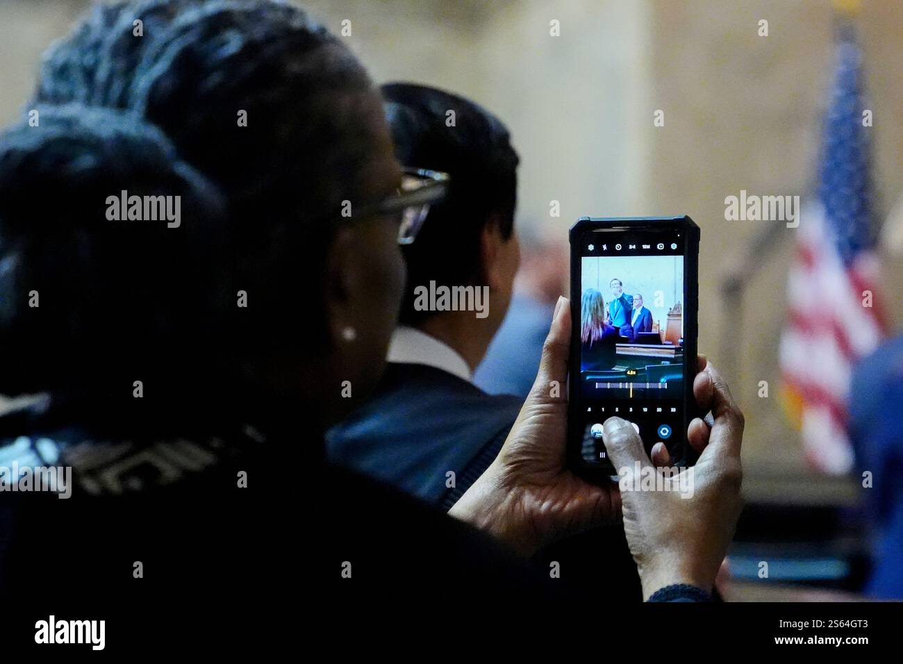 Washington Supreme Court justice Helen Whitener takes a photo as Gov ...