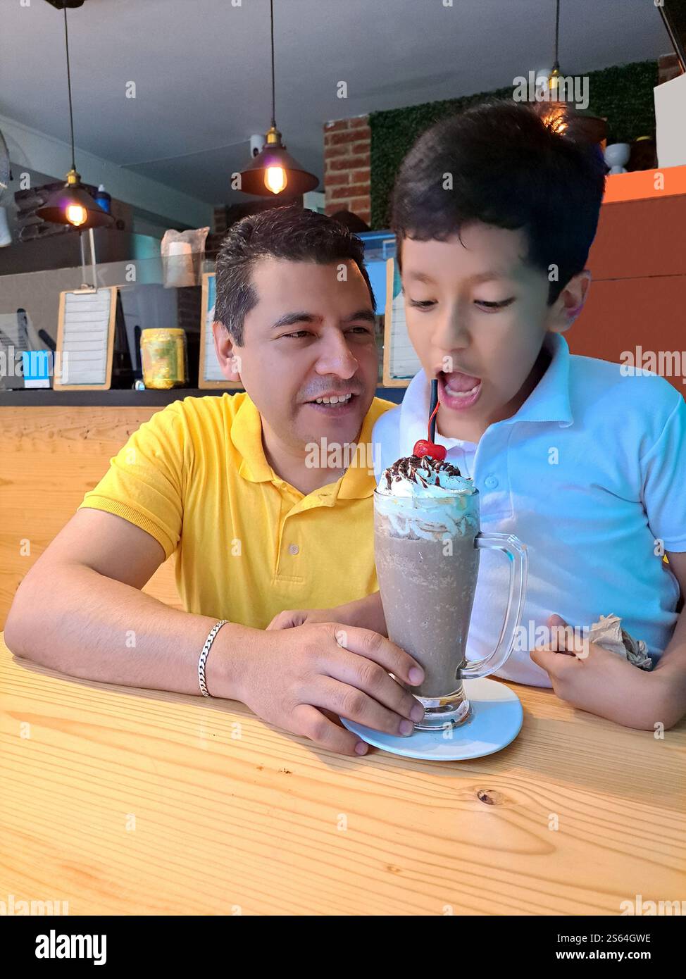 Divorced single dad with his 9 year old son have a milkshake in a ...