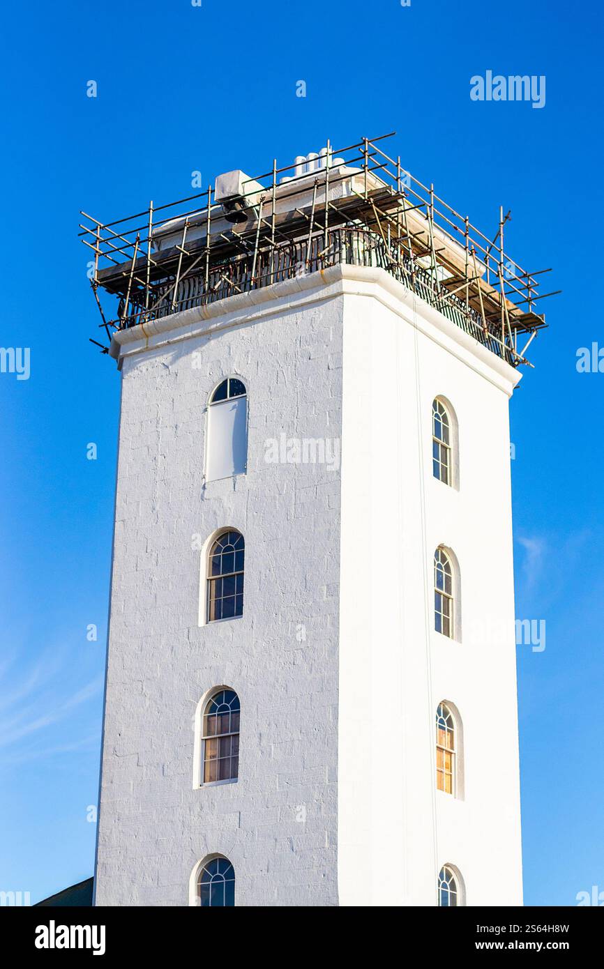 white fish quay lighthouse under renovation with scaffolding against a ...
