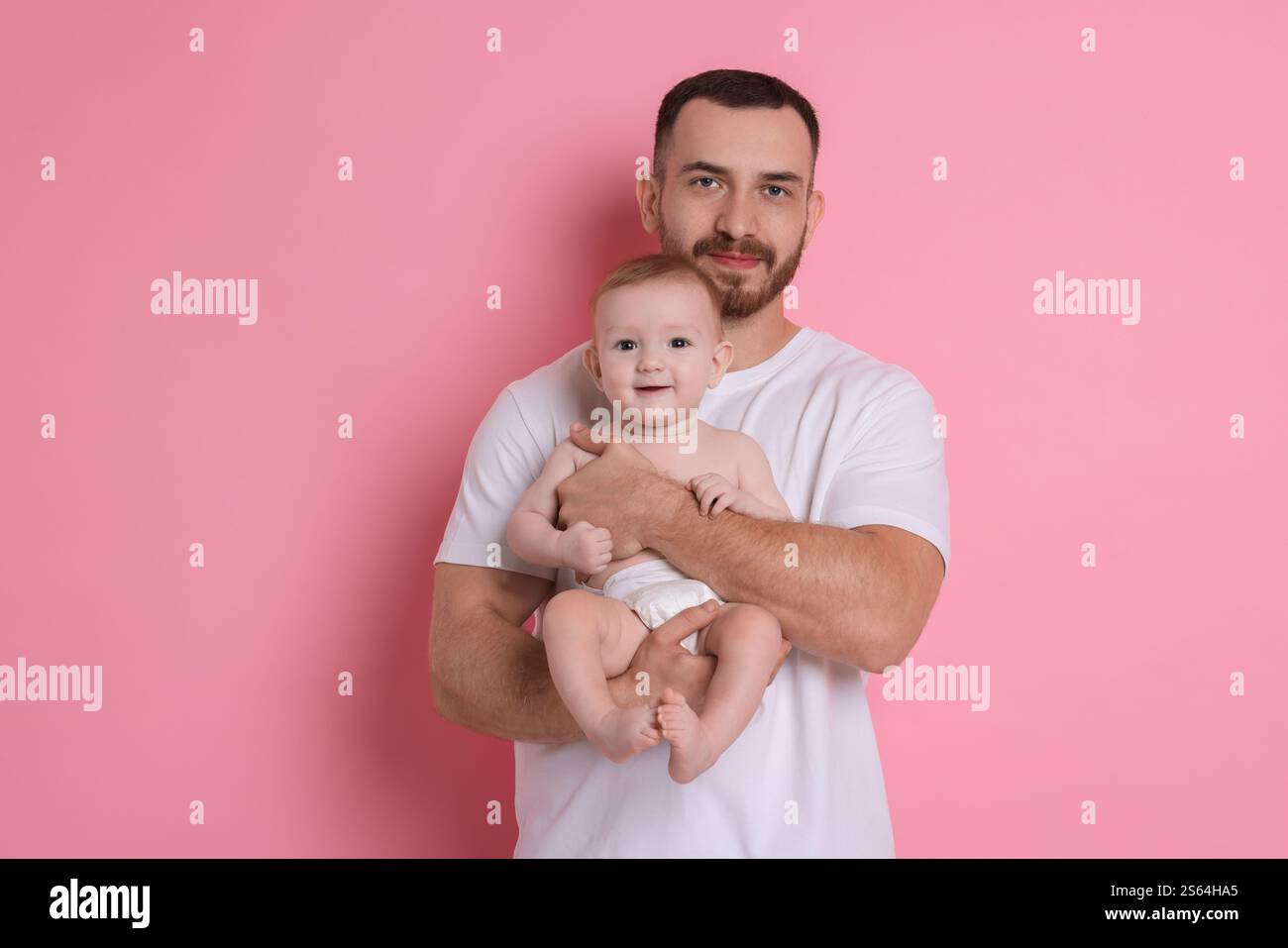 Father with his cute baby on pink background Stock Photo - Alamy