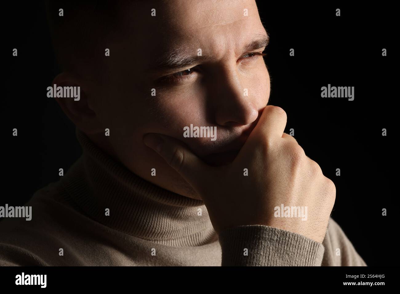 Distressed young man crying on black background, closeup Stock Photo ...