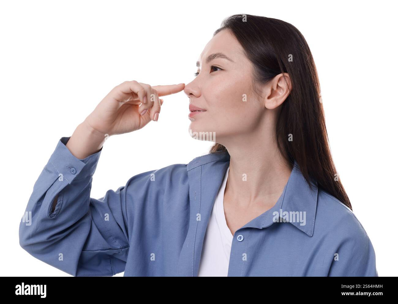 Young woman touching her nose on white background Stock Photo - Alamy