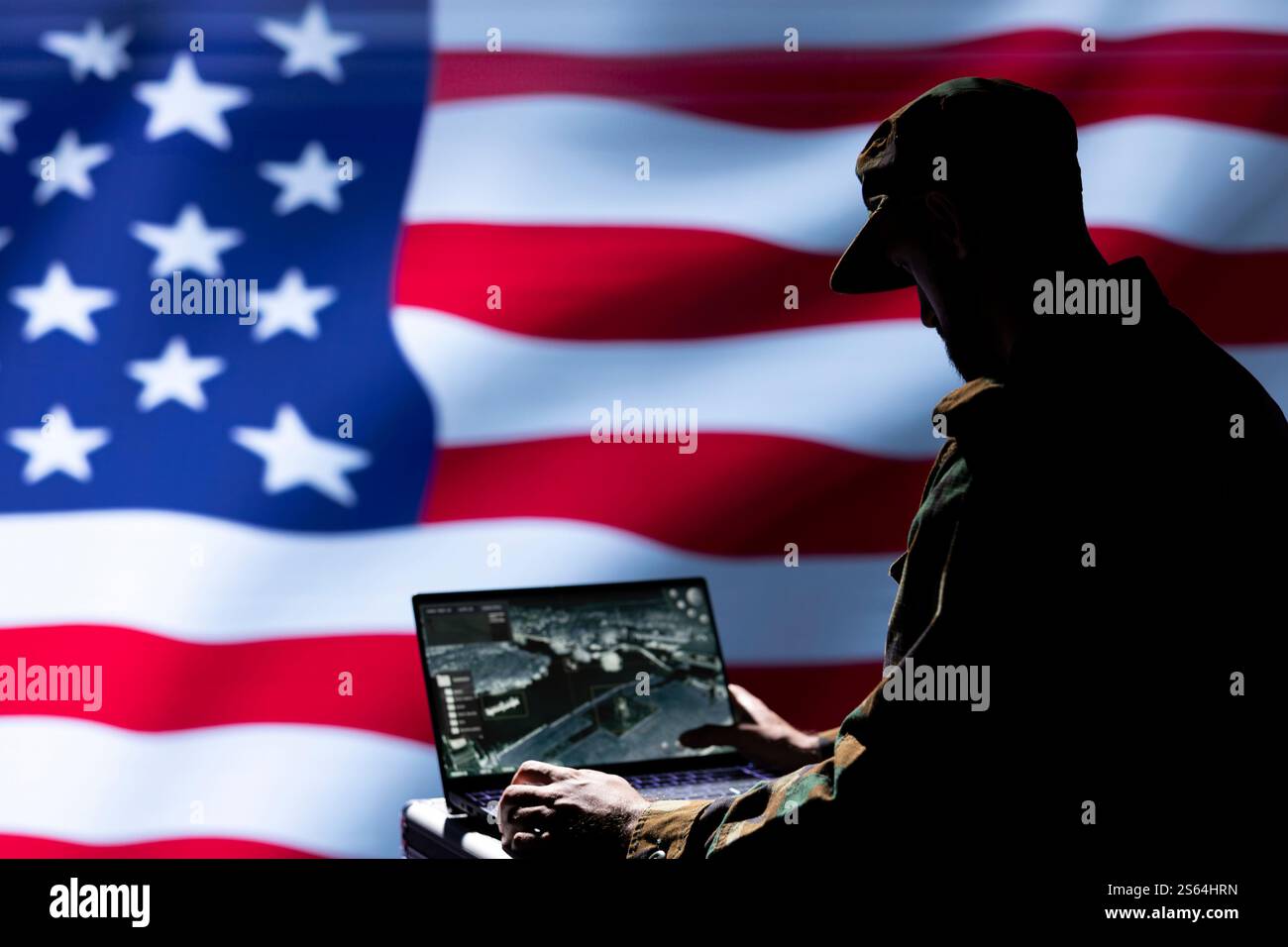 US Air Force security officer using reconnaissance software on laptop ...