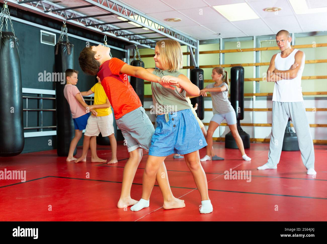 Children practicing self defence technique in pairs Stock Photo - Alamy