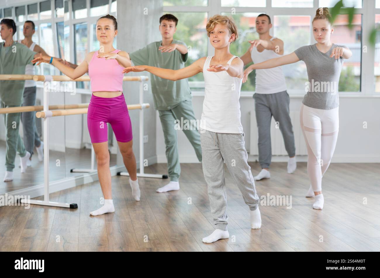 Girls and boys are learning various dance and ballet movements in ...