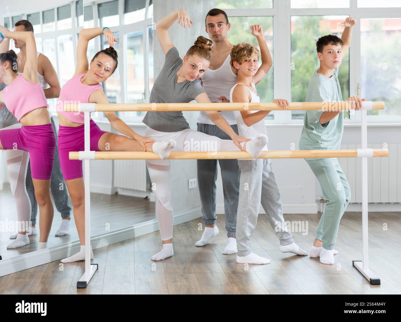 Ballet pose grand batman - girls and boys at a choreography lesson are ...