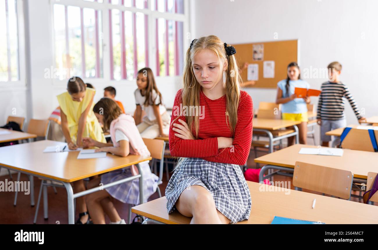 Portrait of sad schoolgirl in classroom Stock Photo - Alamy