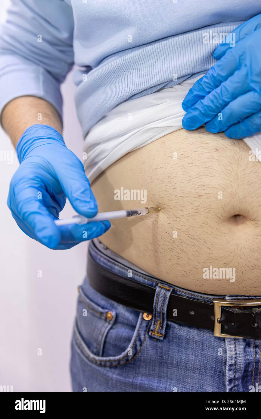How to properly give yourself subcutaneous injection in your stomach concept. Cropped photo of a ...