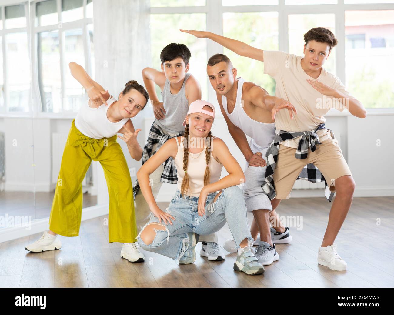 Group of young teenage hip hop dancers, together with dance teacher ...