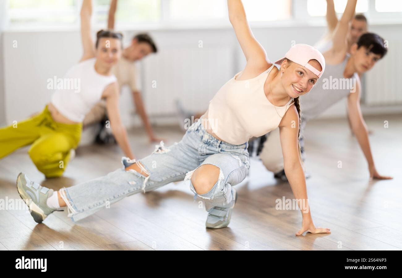 Group of young friends learn group dances - low break and breakdance in ...
