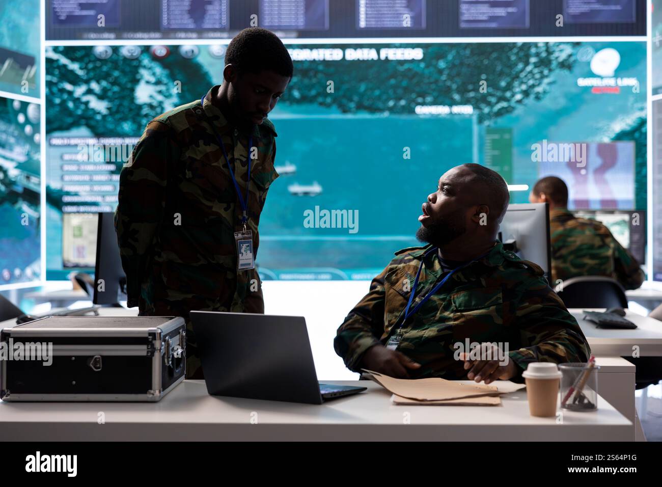 Soldiers team examining real time satellite data and details from old ...
