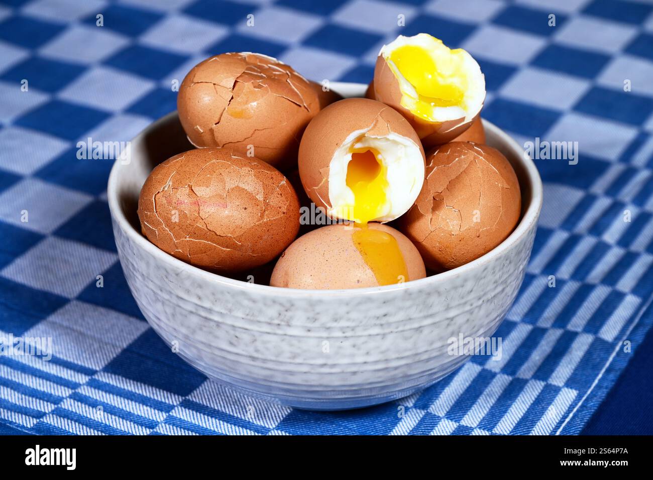 Broken soft-boiled chicken eggs in a bowl Stock Photo - Alamy
