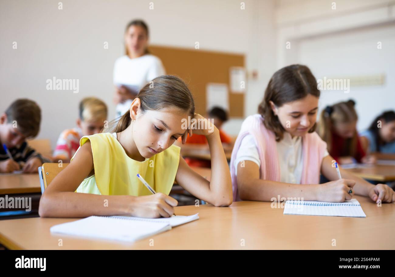 Young girls learning subjects in classroom Stock Photo - Alamy