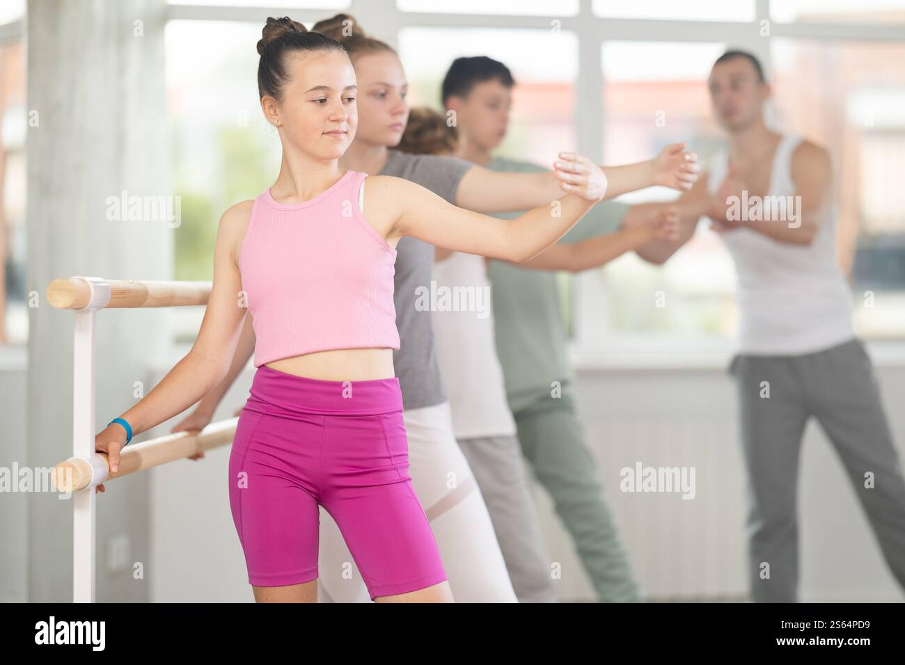 Teenage girl practicing ballet positions in dance studio Stock Photo ...