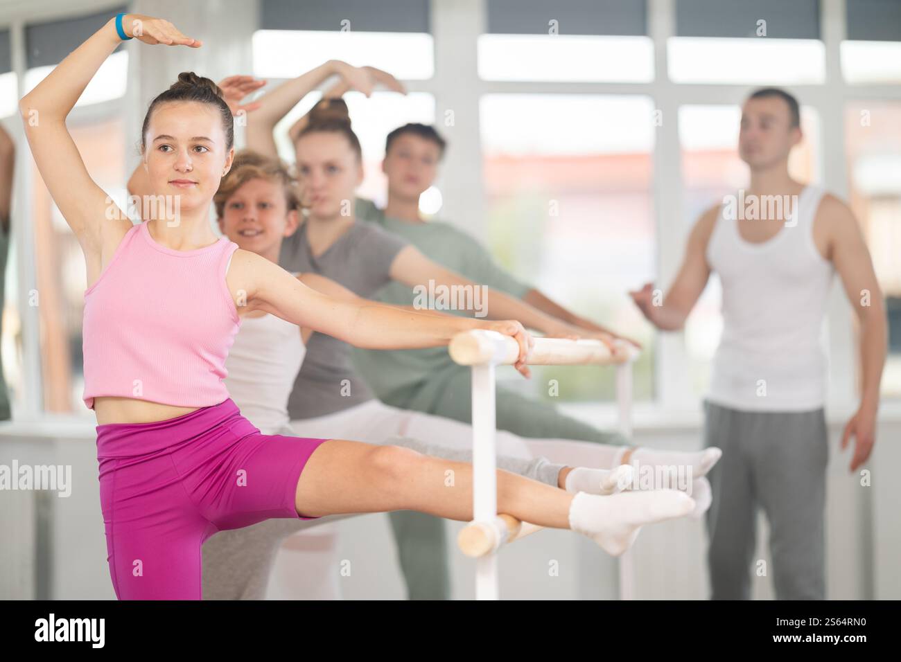 Ballet pose grand batman - girls and boys at a choreography lesson are ...