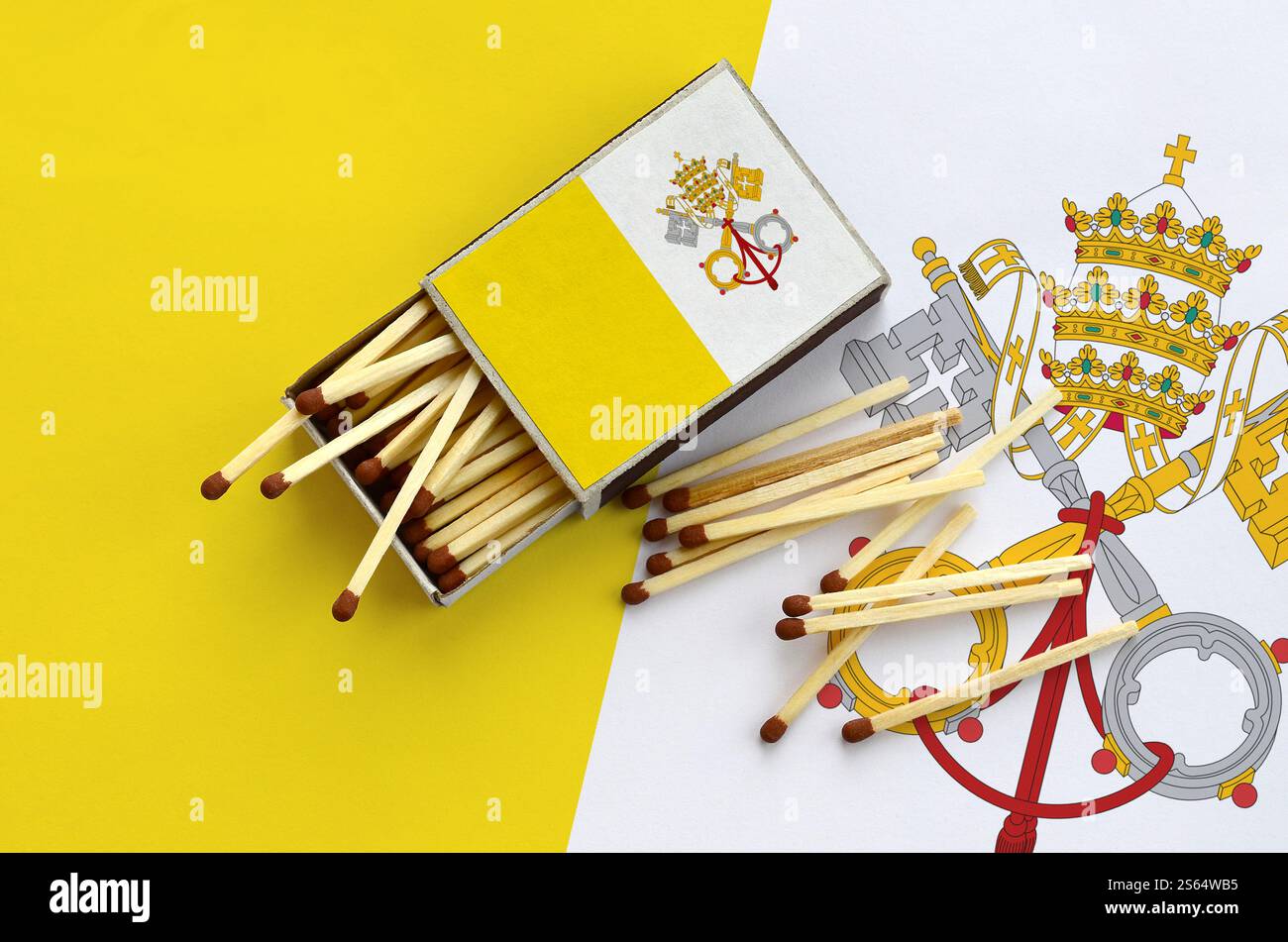 Vatican City State flag is shown on an open matchbox, from which ...