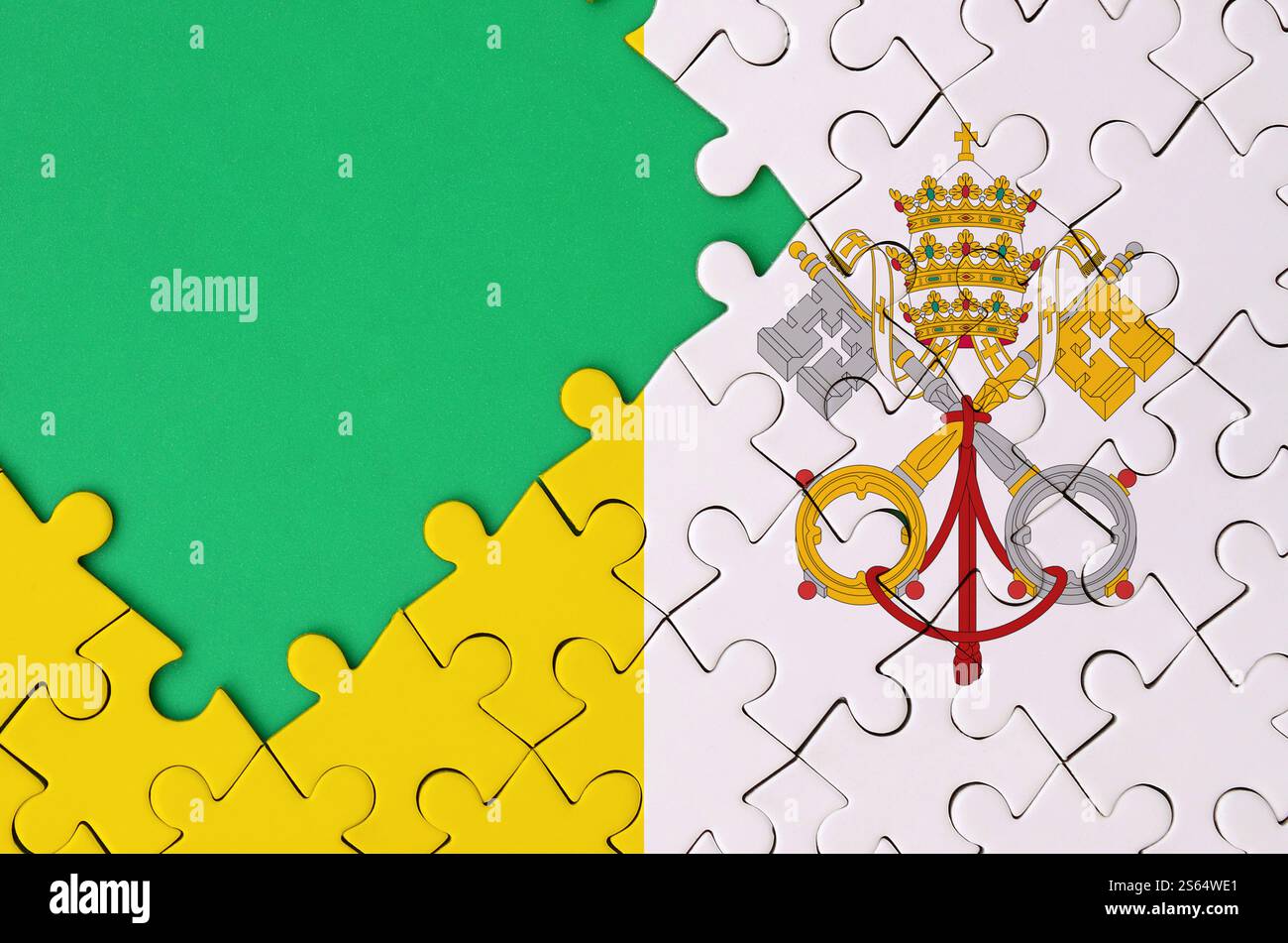 Vatican City State flag is depicted on a completed jigsaw puzzle with ...