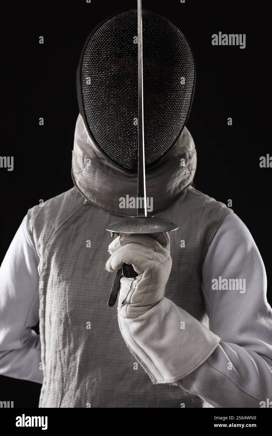 Fencer with epee on black background. Combat sport Stock Photo - Alamy