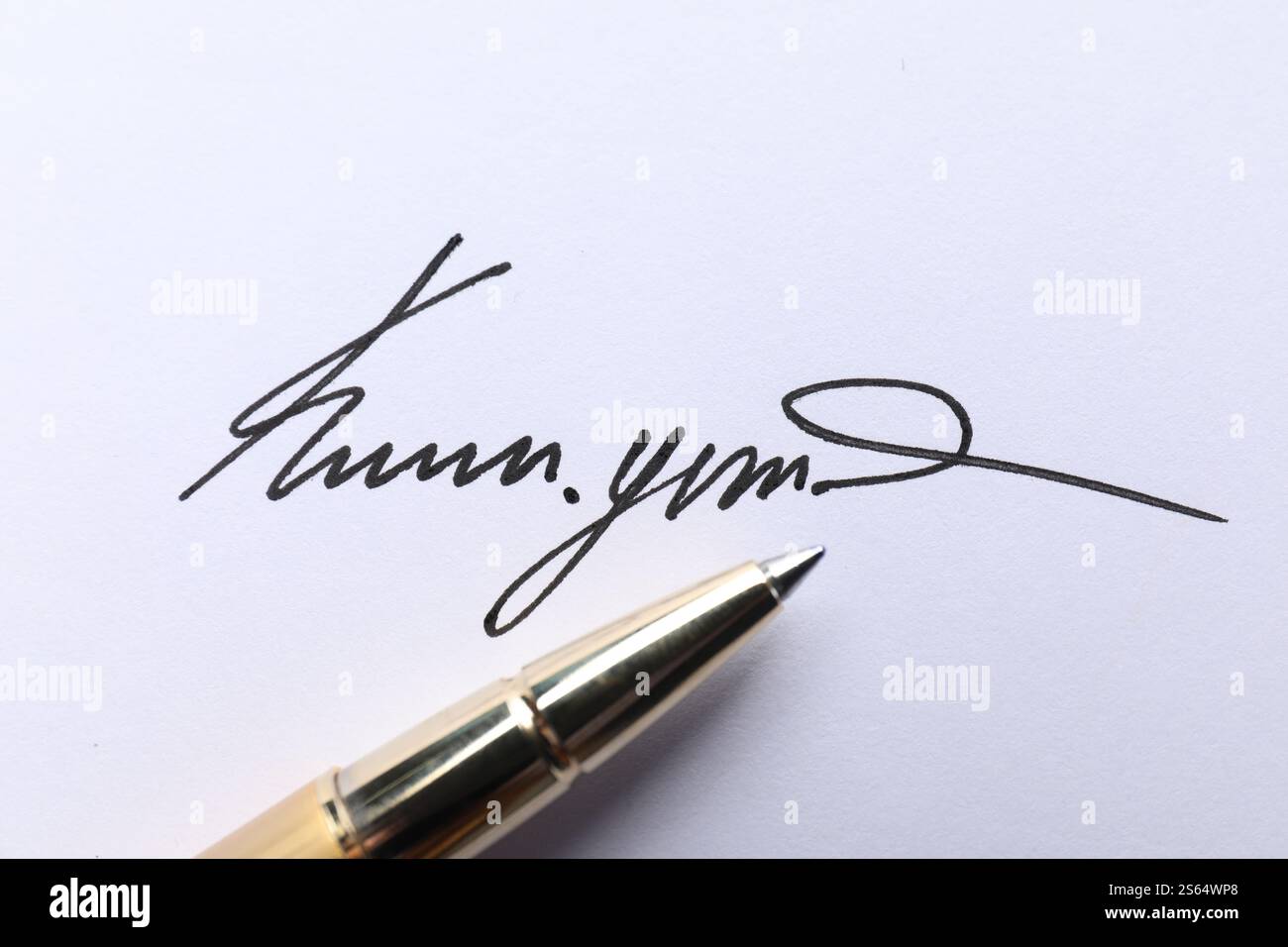 Pen and signature on white paper, closeup Stock Photo - Alamy
