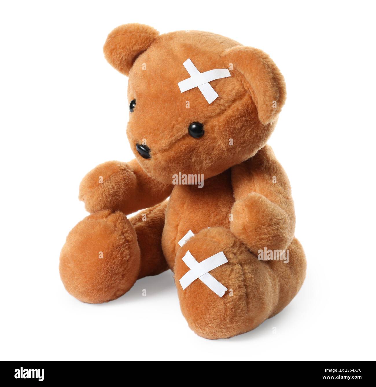 Teddy bear with adhesive medical bandages isolated on white Stock Photo ...