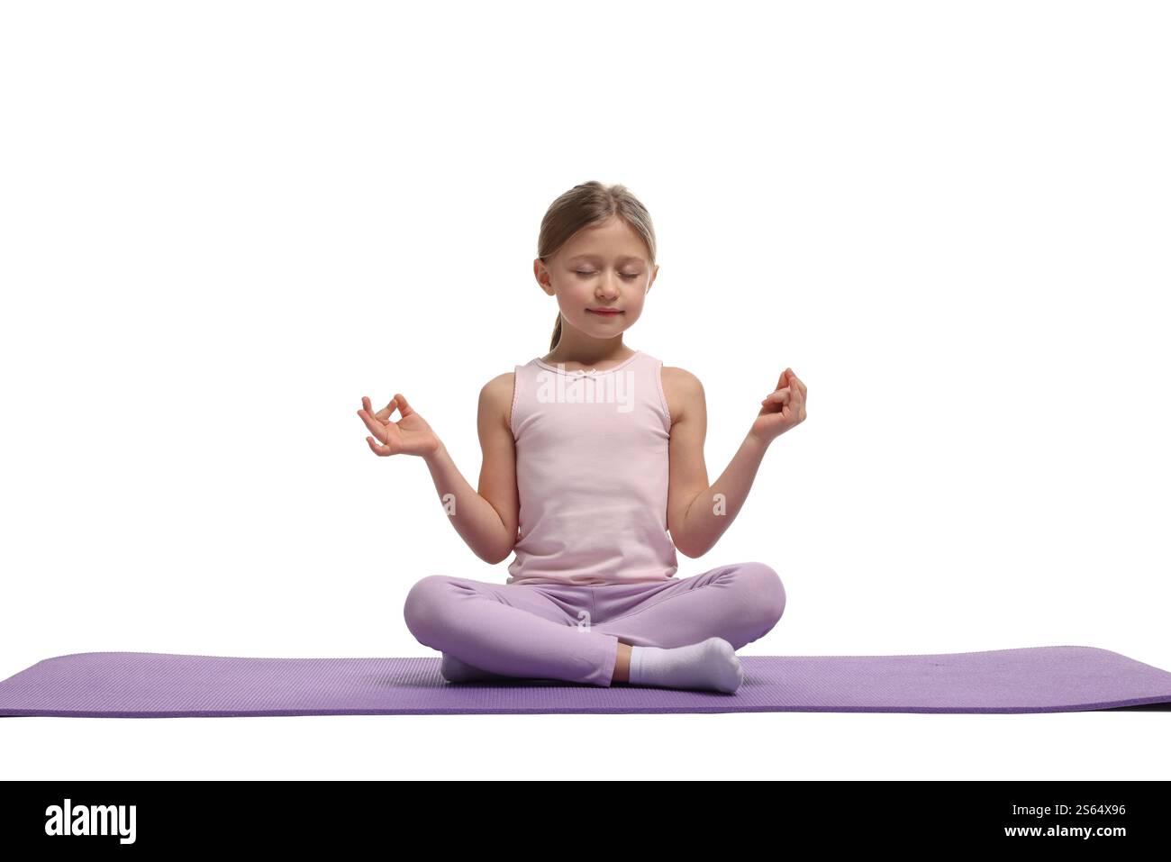Little girl exercising on fitness mat against white background Stock ...