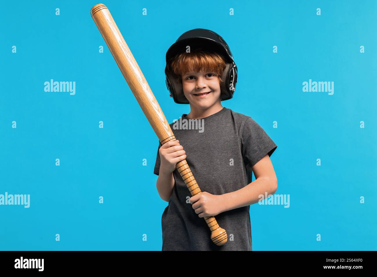 Little boy in helmet with baseball bat on light blue background Stock ...