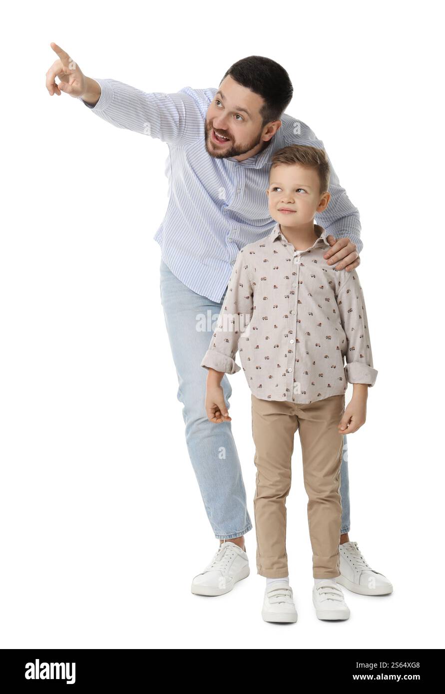 Happy father with his cute little son looking at something on white ...