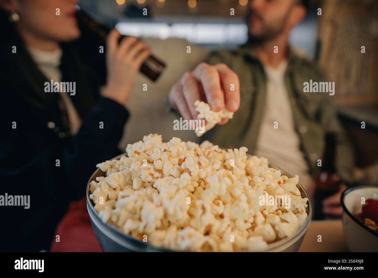 Couple enjoying popcorn and drinks inside camper van Stock Photo - Alamy