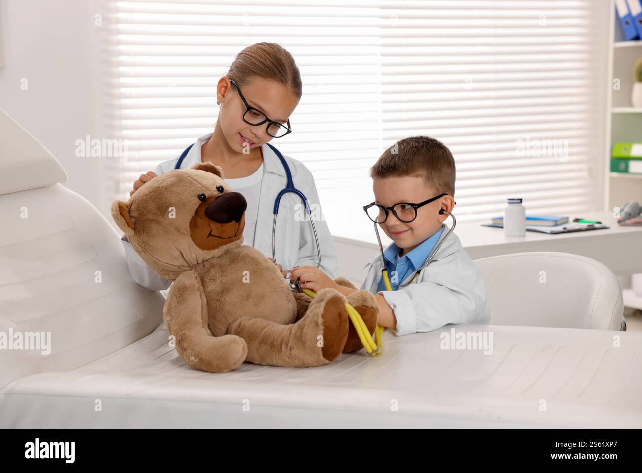Little boy and girl with toy pretending to be doctors indoors Stock ...