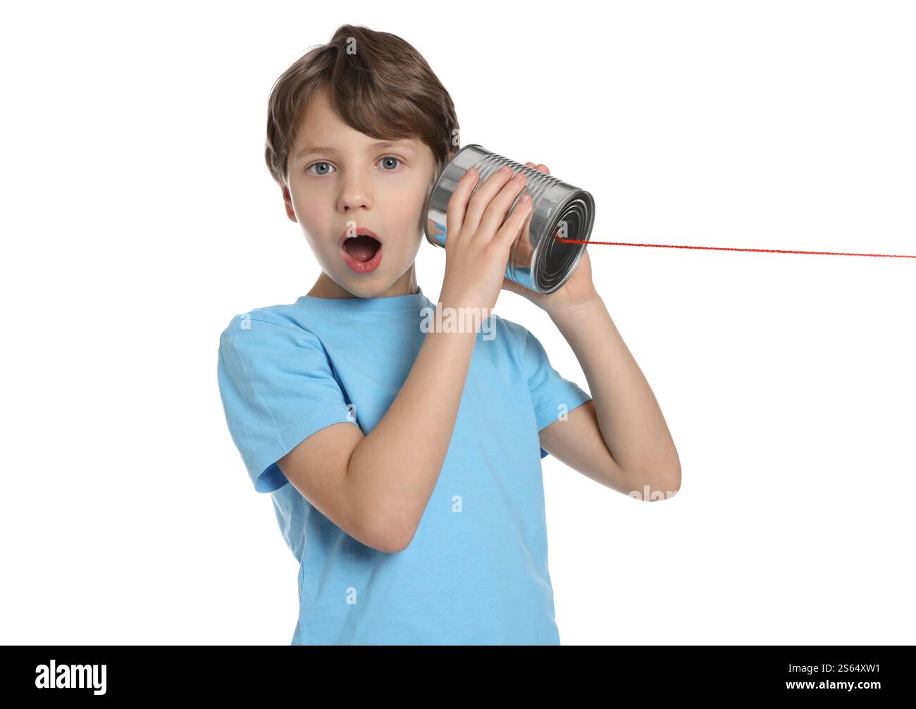 Emotional boy using tin can telephone on white background Stock Photo ...