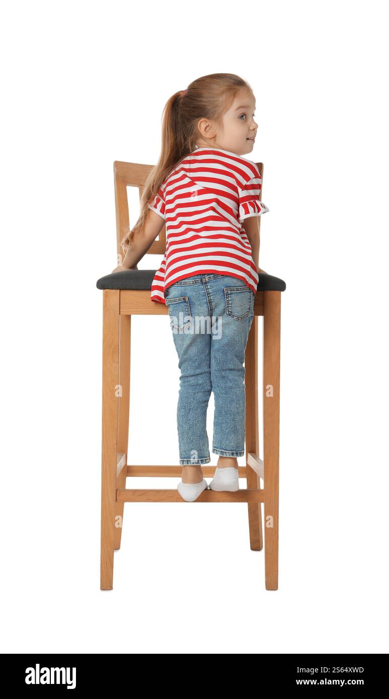Little girl standing on stool against white background Stock Photo - Alamy