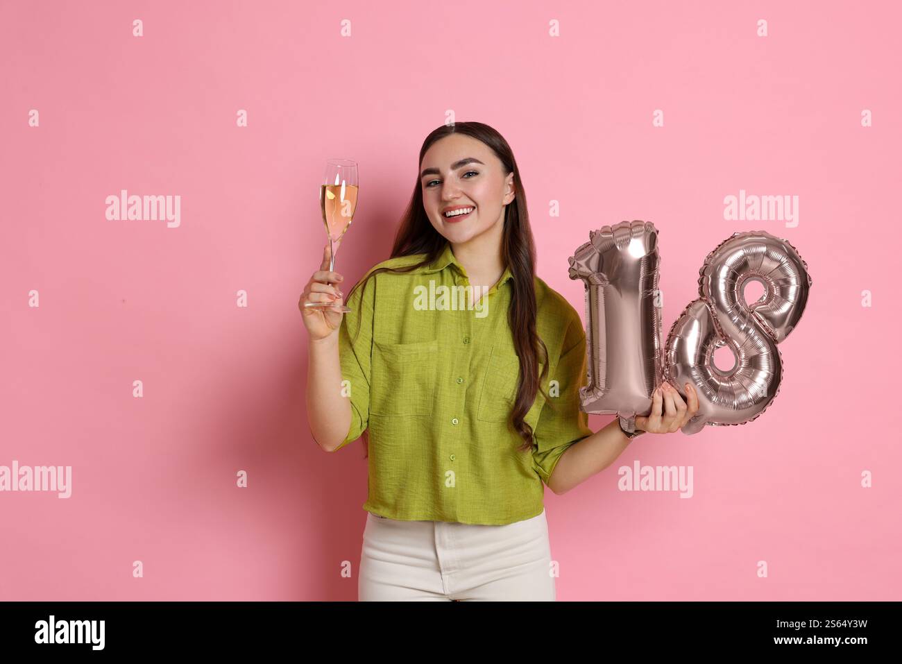 Coming of age party - 18th birthday. Happy young woman with number ...