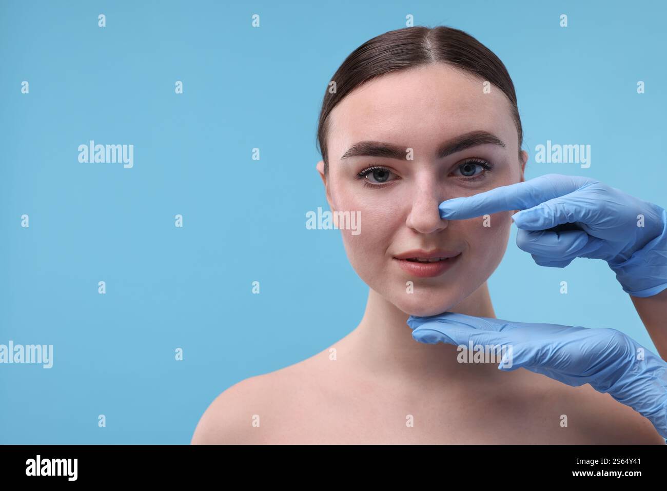 Doctor checking patient's nose before plastic surgery operation on ...
