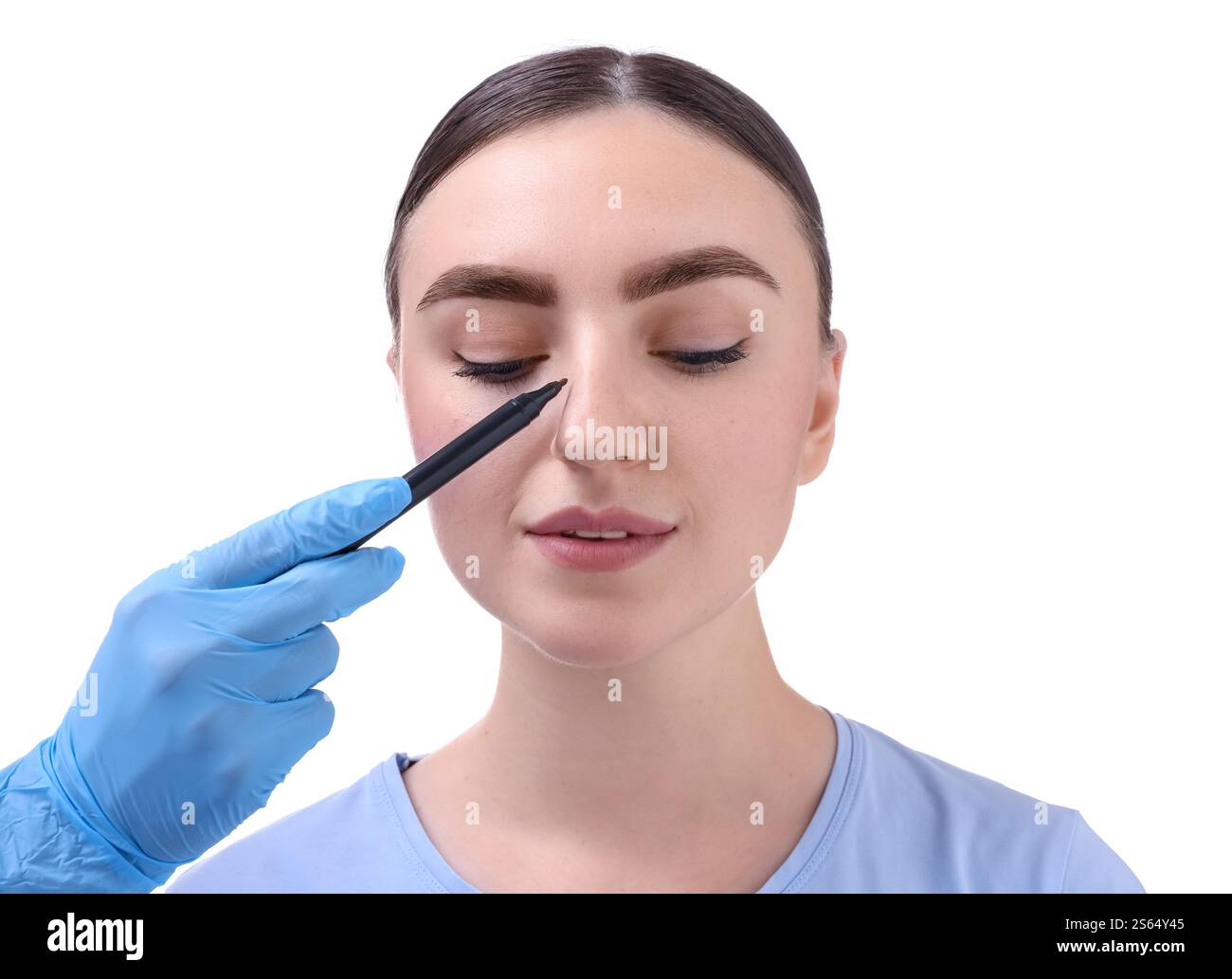 Doctor drawing marks on patient's nose for plastic surgery operation ...