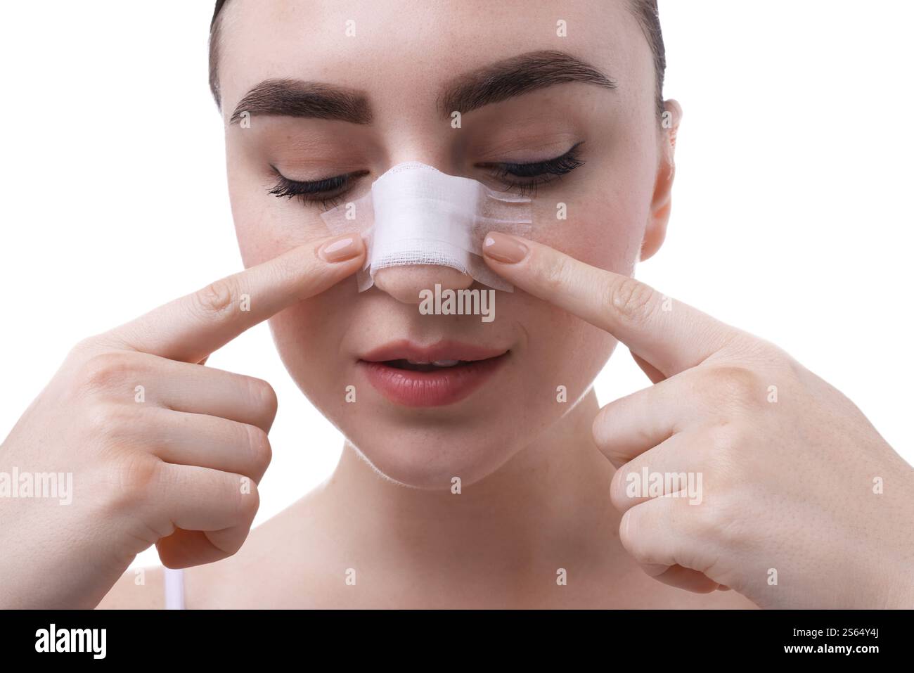Woman with medical bandage on her nose after plastic surgery operation ...