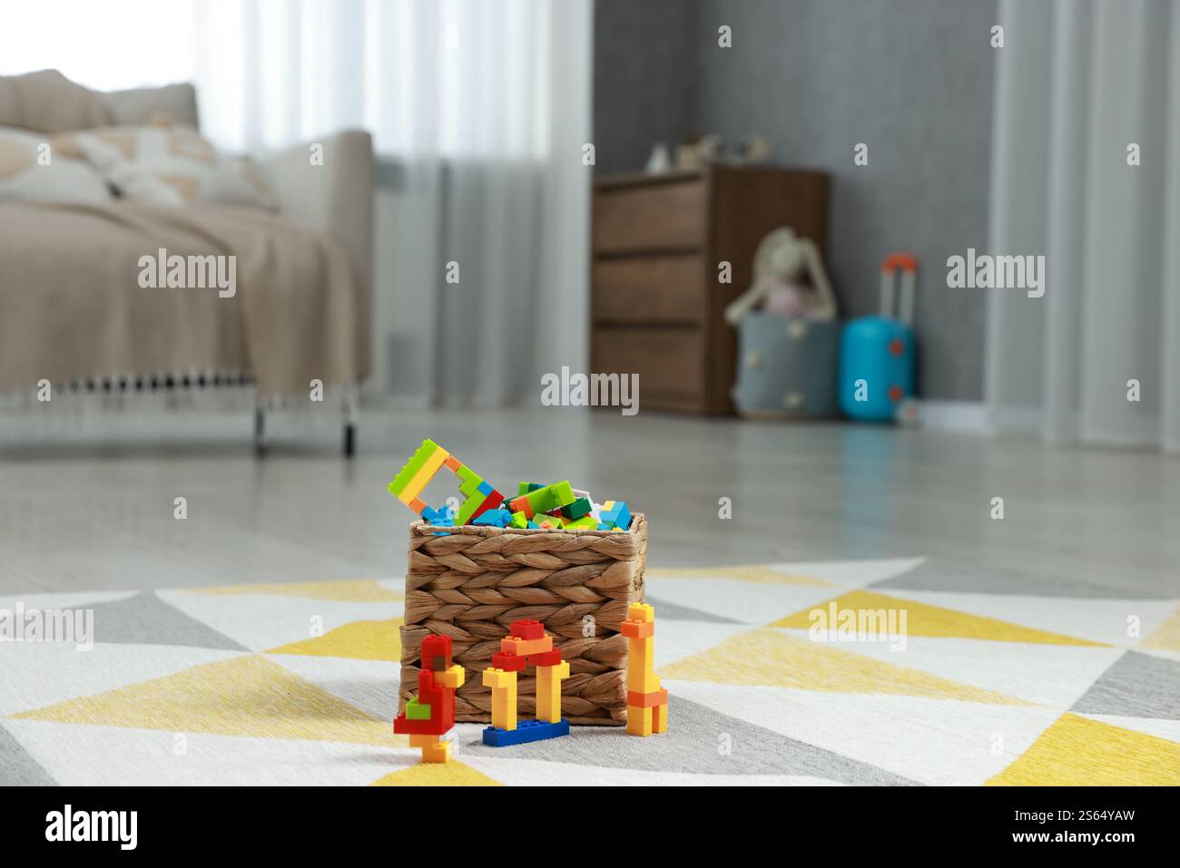 Construction toy. Figures made with building bricks and wicker basket ...