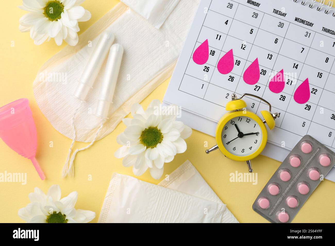 Flat lay composition with calendar and menstrual products on beige ...