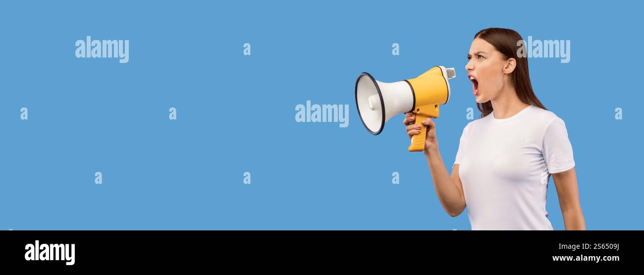 Aggressive woman shouting with megaphone, isolated on purple Stock ...