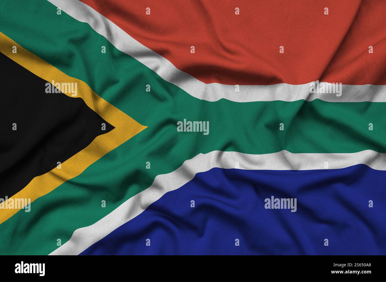 South Africa flag is depicted on a sports cloth fabric with many folds ...