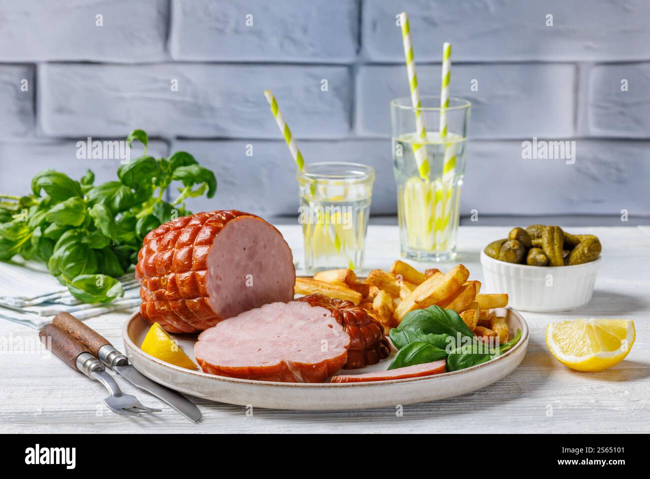 boneless smoked holiday ham with fried potatoes on plate on white ...