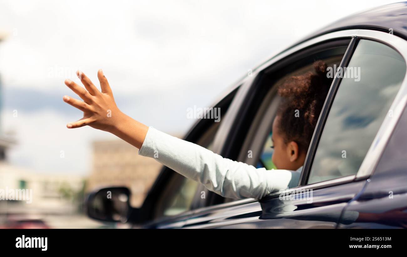 African Girl Putting Arm Out Of Car Window In City Stock Photo - Alamy