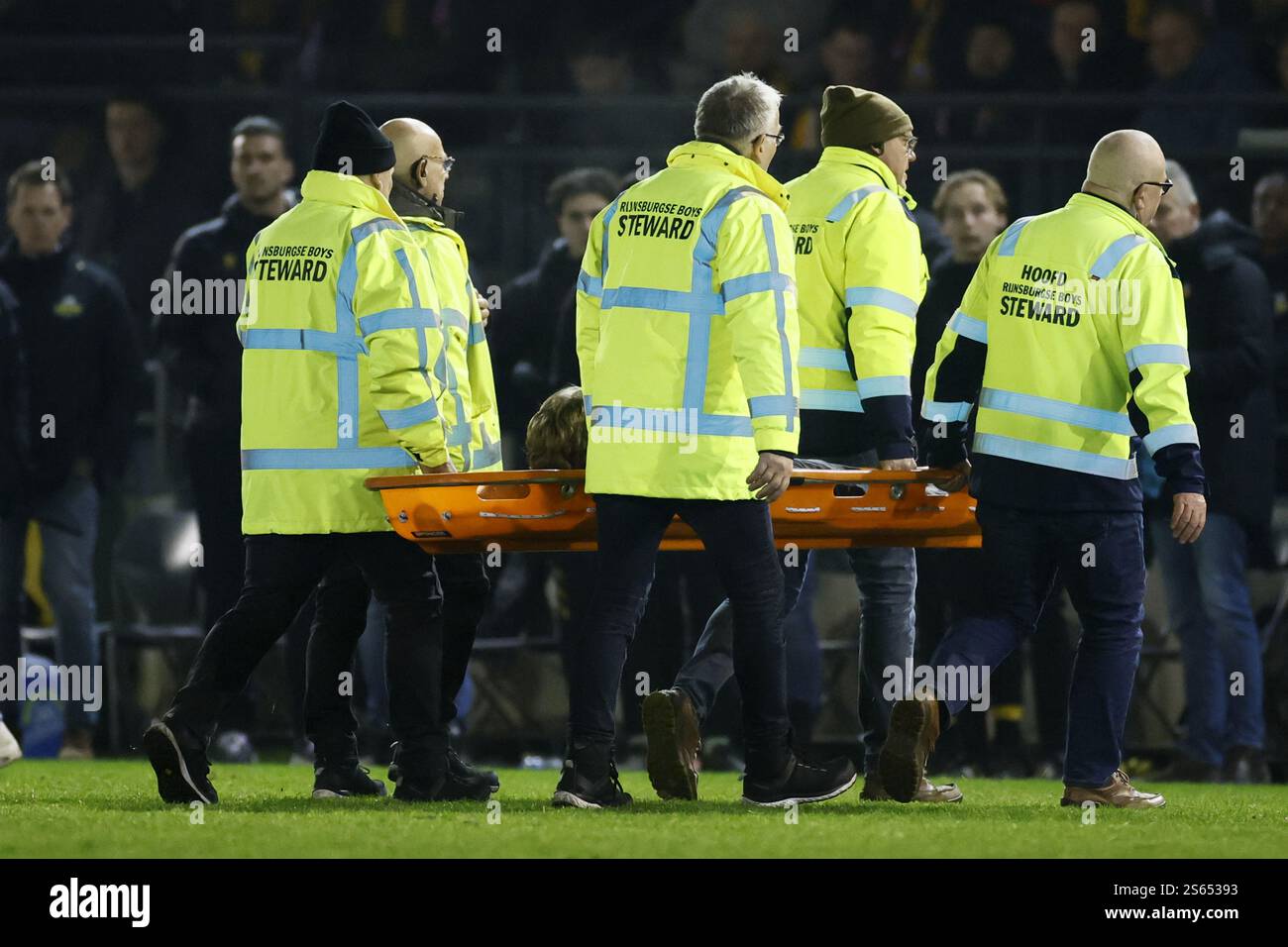 RIJNSBURG - A supporter is carried off the field by stretcher during ...