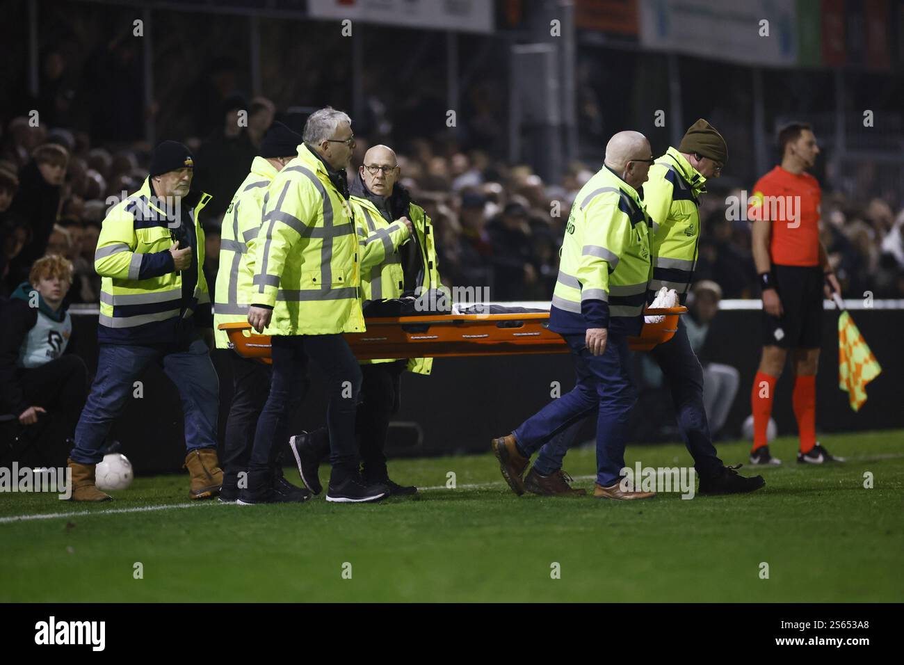 RIJNSBURG - A supporter is carried off the field by stretcher during ...