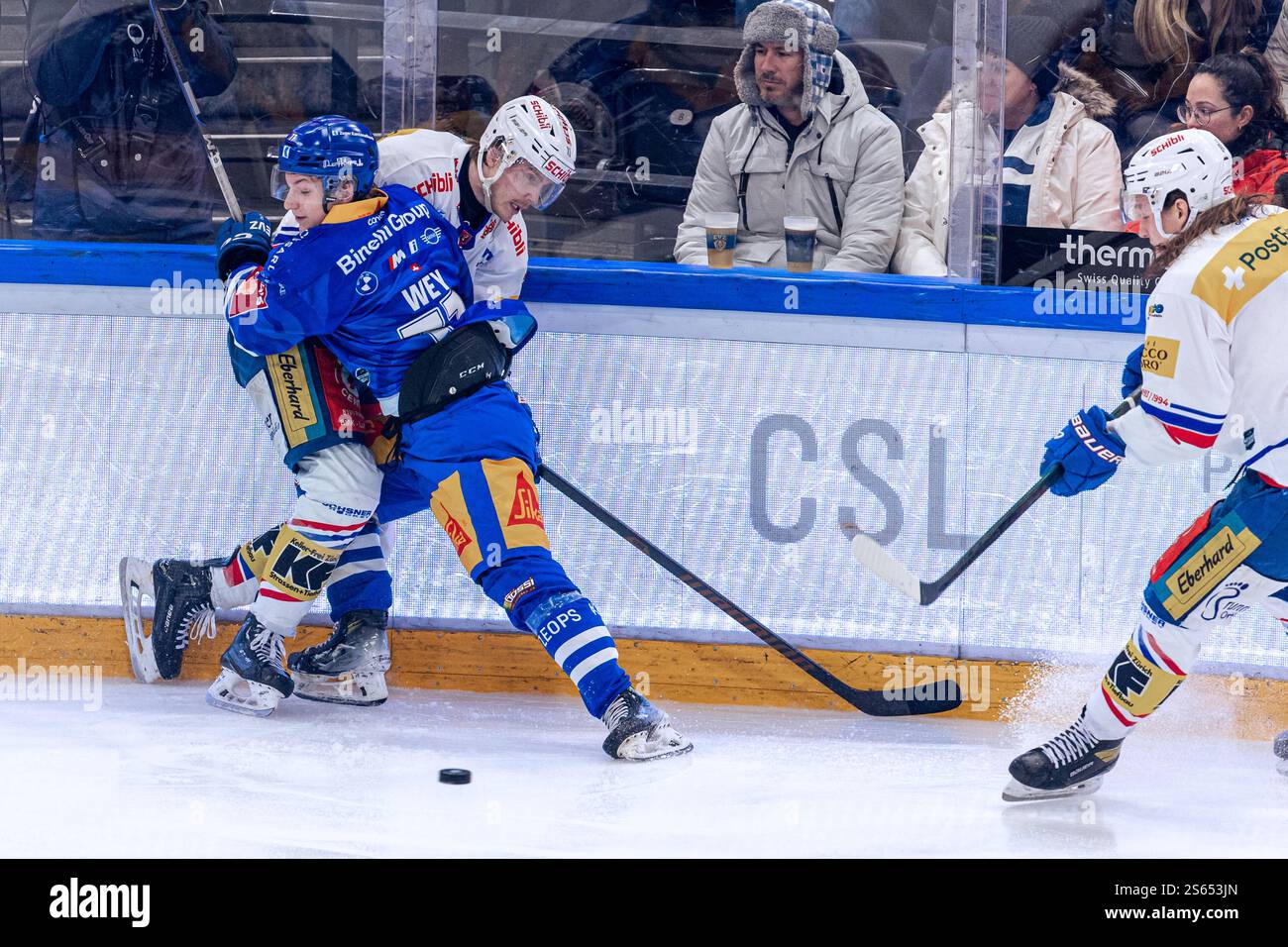 Loris Wey #77 (EV Zug) pushes Keanu Derungs #11 (EHC Kloten) against ...