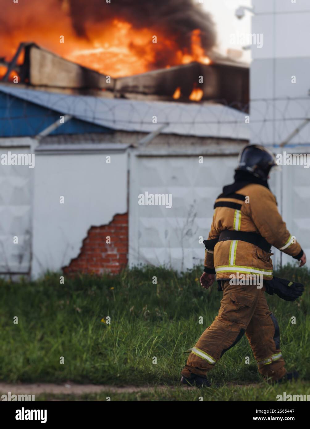 Group of fire men in uniform during fire fighting operation in the city ...