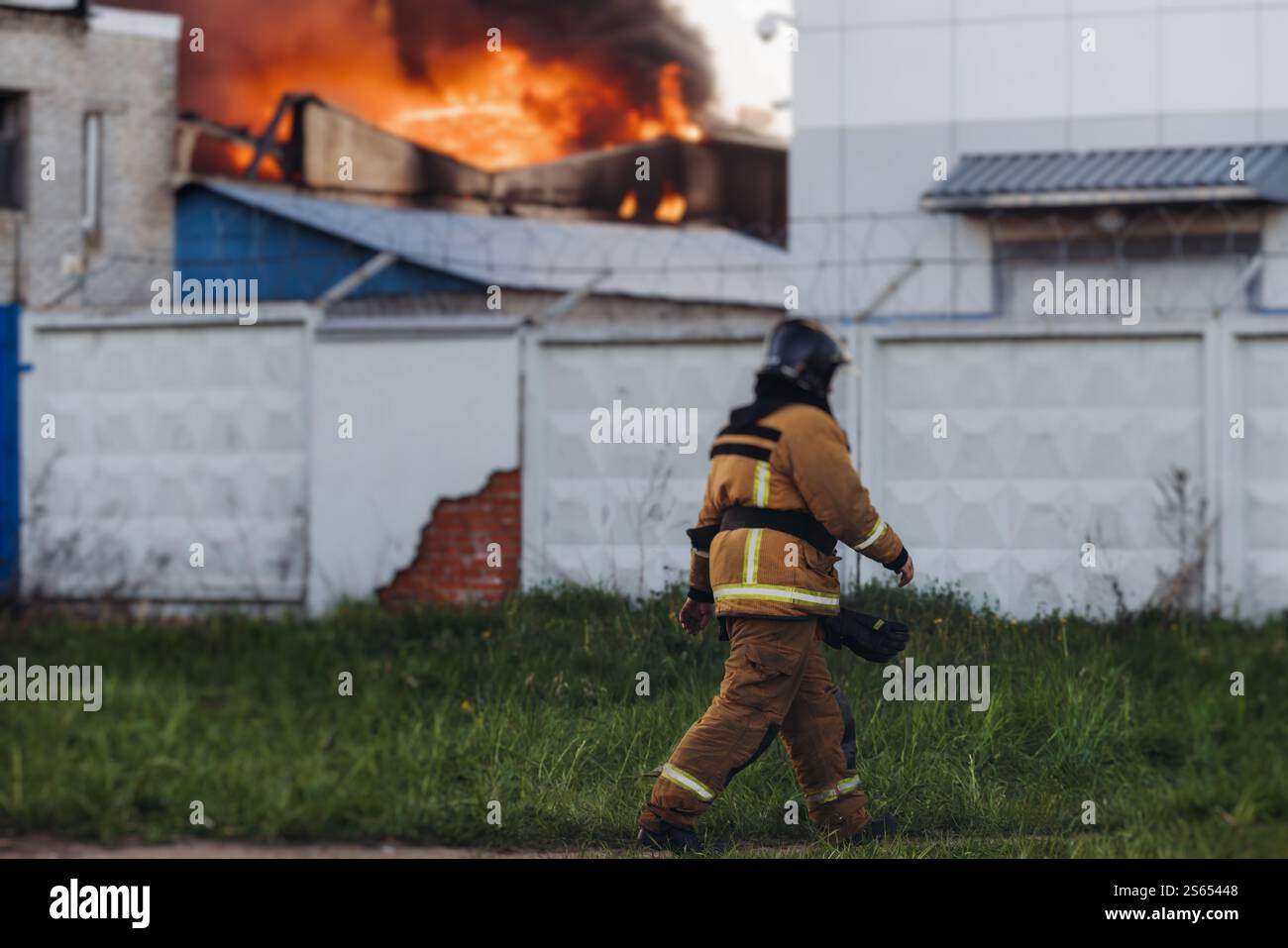 Group of fire men in uniform during fire fighting operation in the city ...