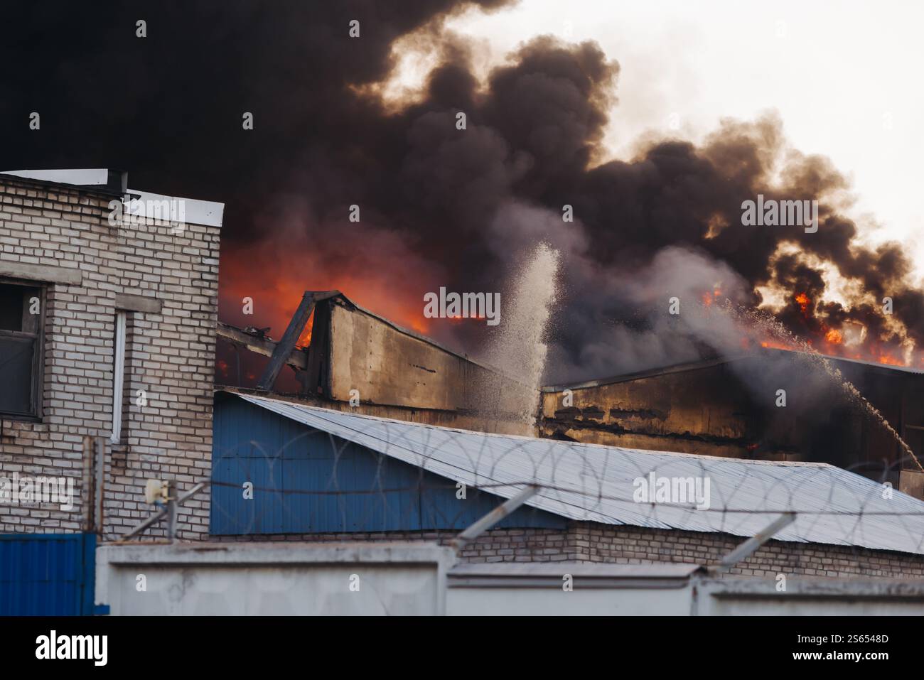 Massive large blaze fire in the city, blazing warehouse factory ...
